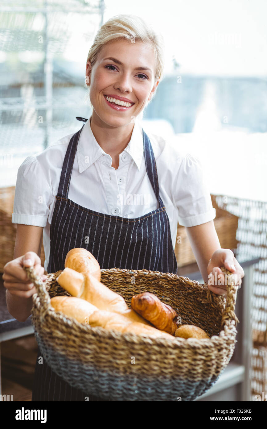 Pretty waitress carrying basket of bread Stock Photo - Alamy