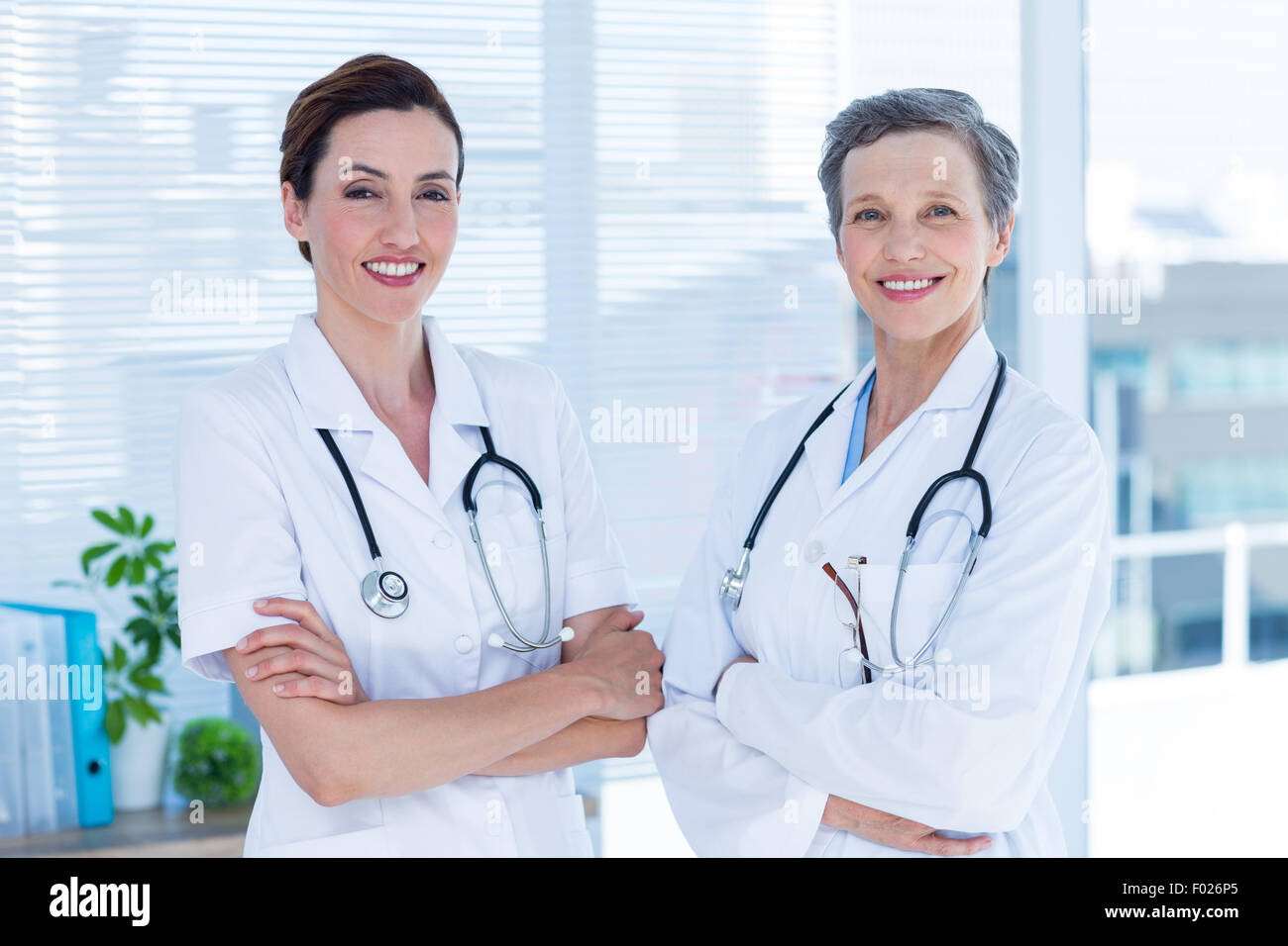Portrait of smiling medical colleagues with arms crossed Stock Photo ...
