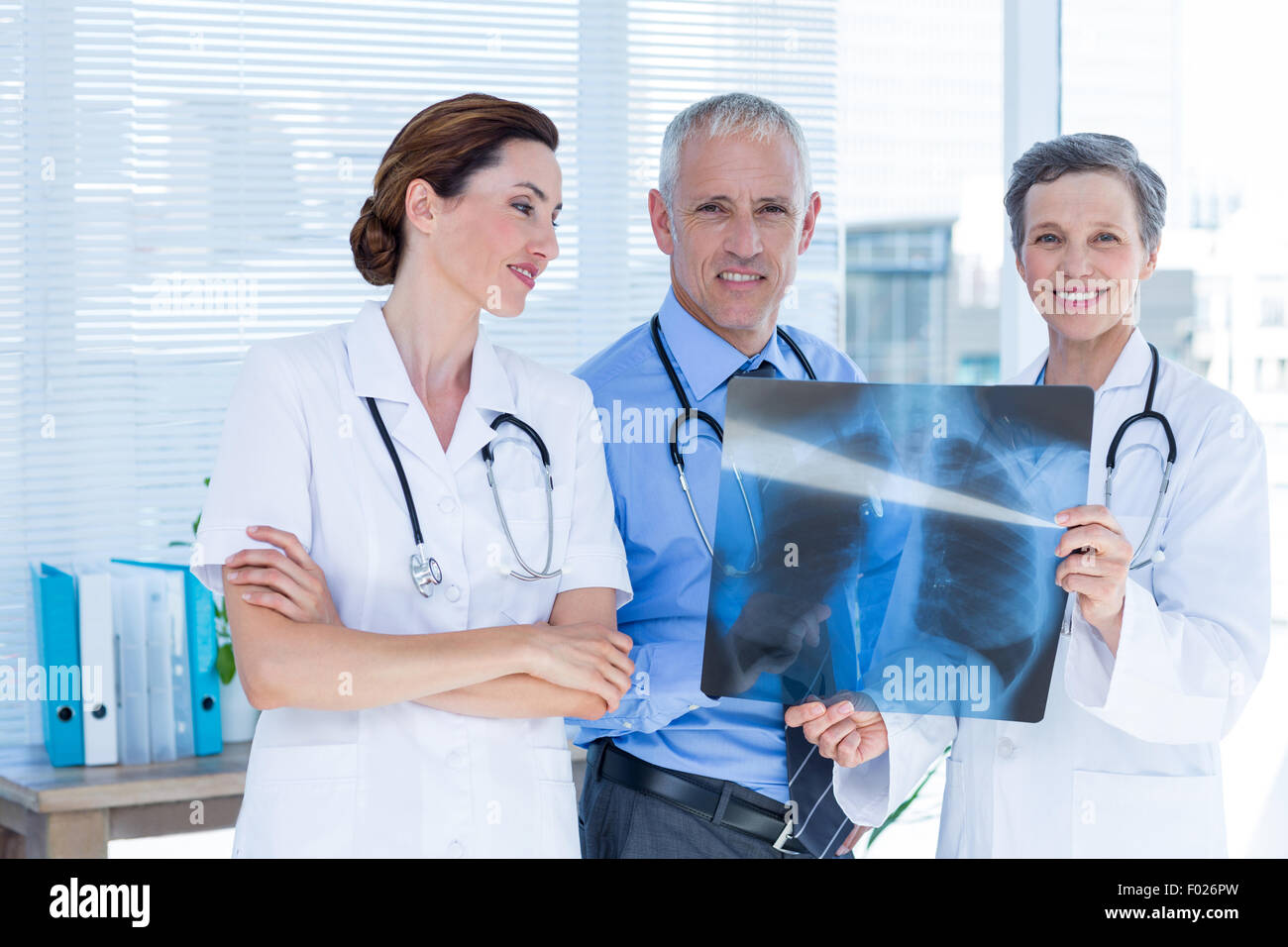 Portrait of smiling medical colleagues examining x-ray together Stock ...