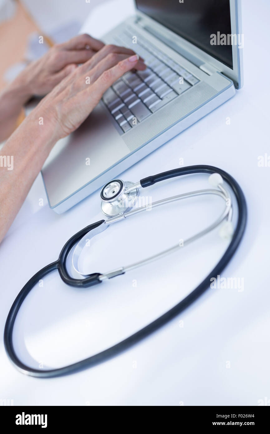 Close up view of female doctor using laptop Stock Photo - Alamy