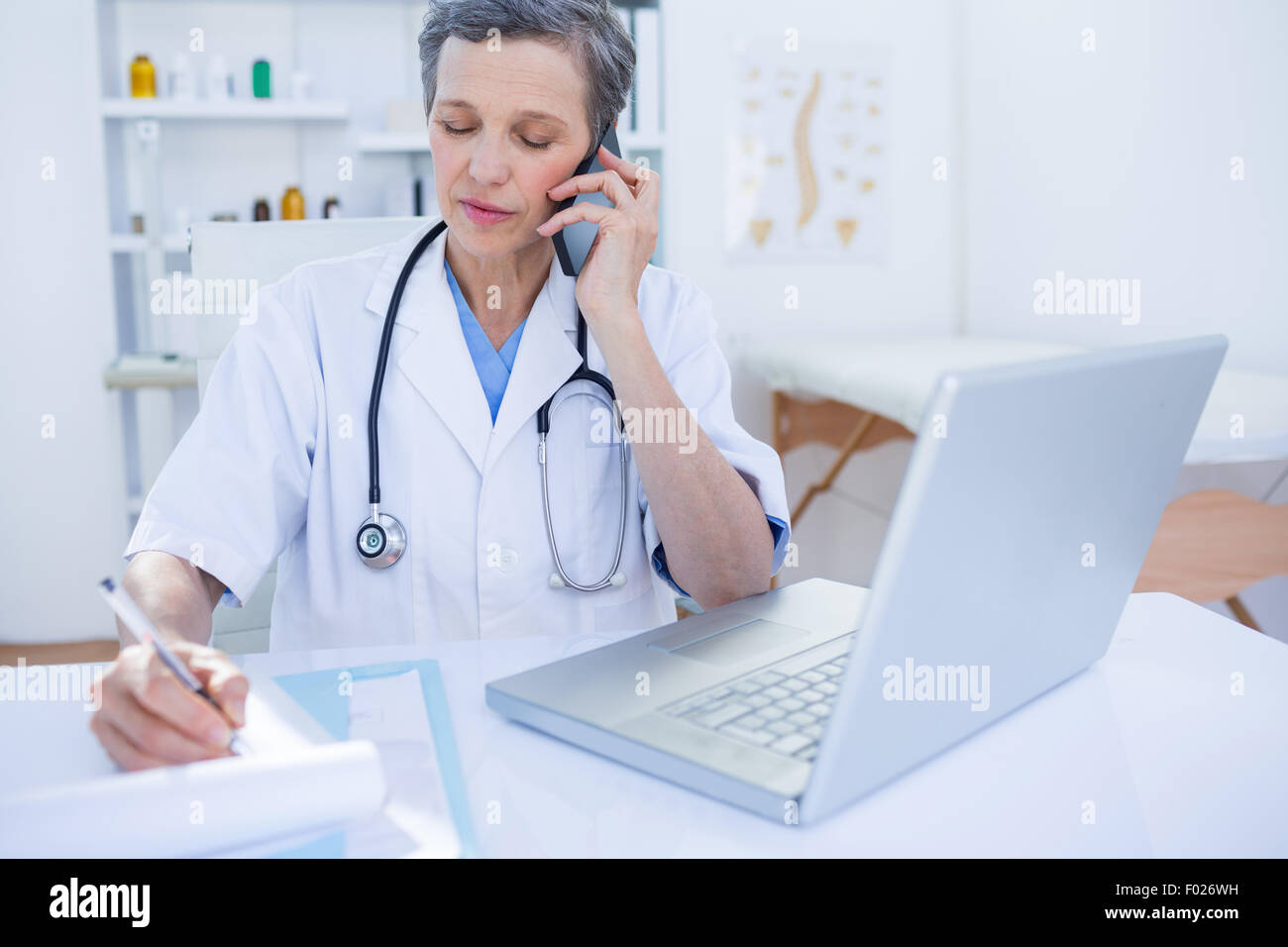Female doctor having a phone call Stock Photo - Alamy