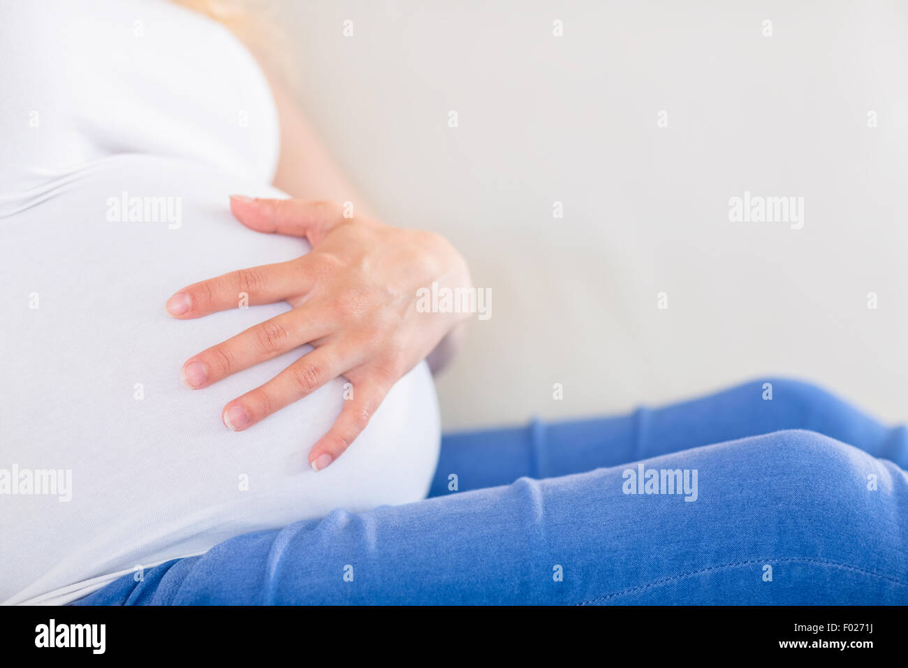 Woman with hand on pregnant belly hi-res stock photography and images ...