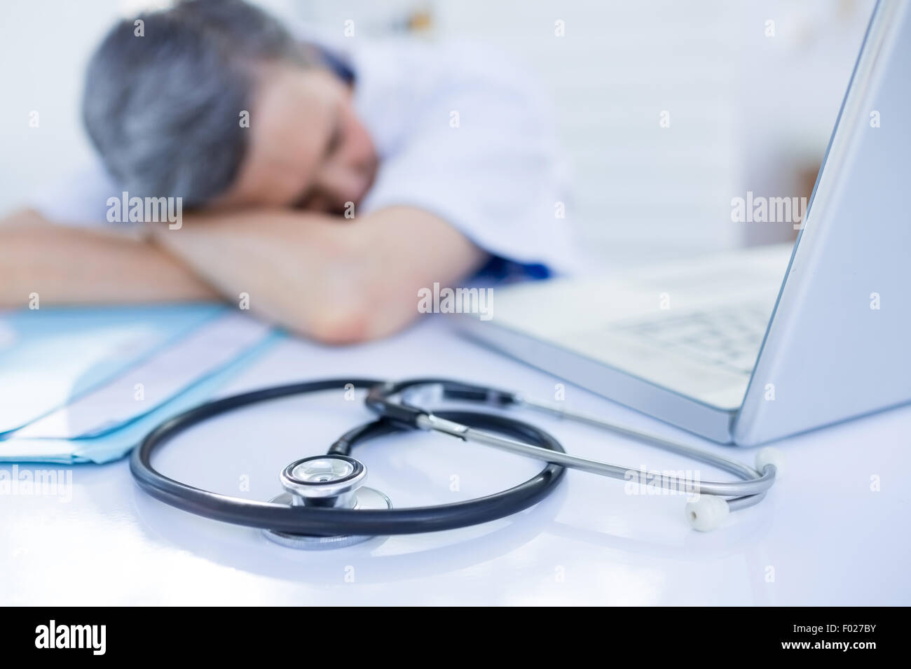 Female doctor sleeping on desk Stock Photo - Alamy
