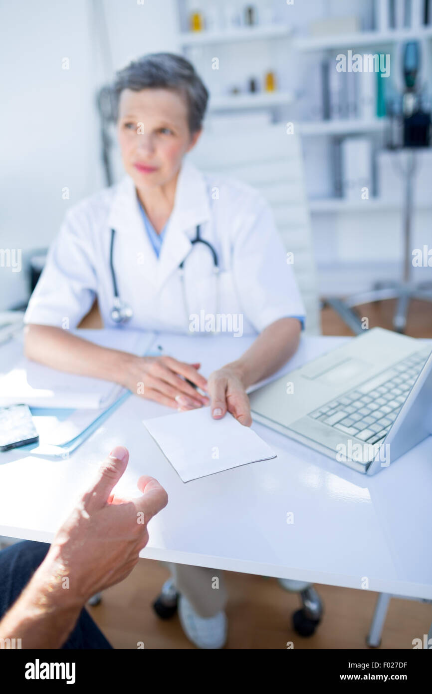 Female doctor giving prescription to her patient Stock Photo - Alamy