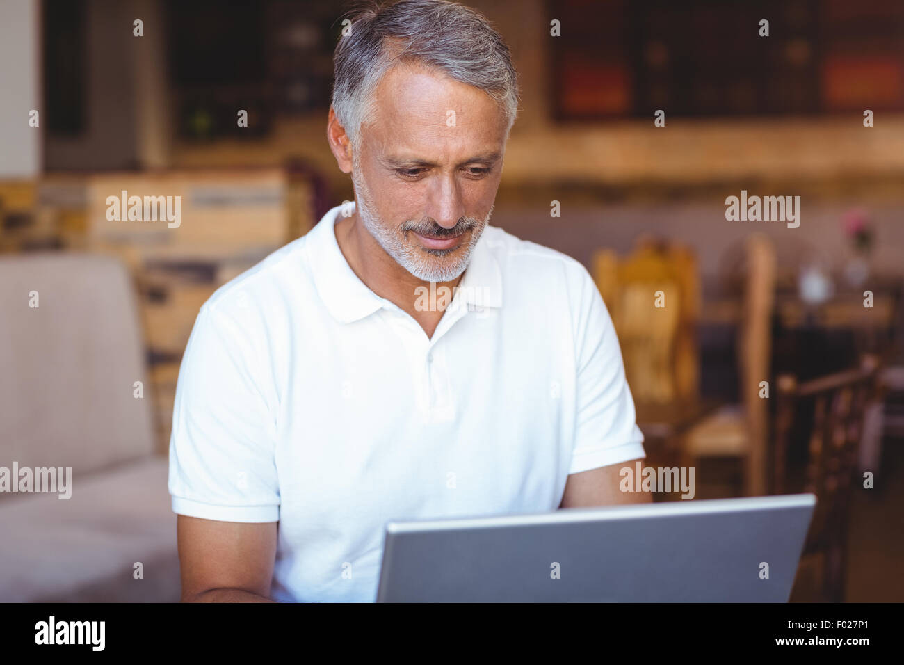 Happy man using his laptop computer Stock Photo - Alamy