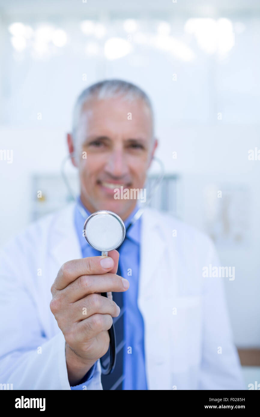 Happy doctor smiling at camera and showing his stethoscope Stock Photo ...