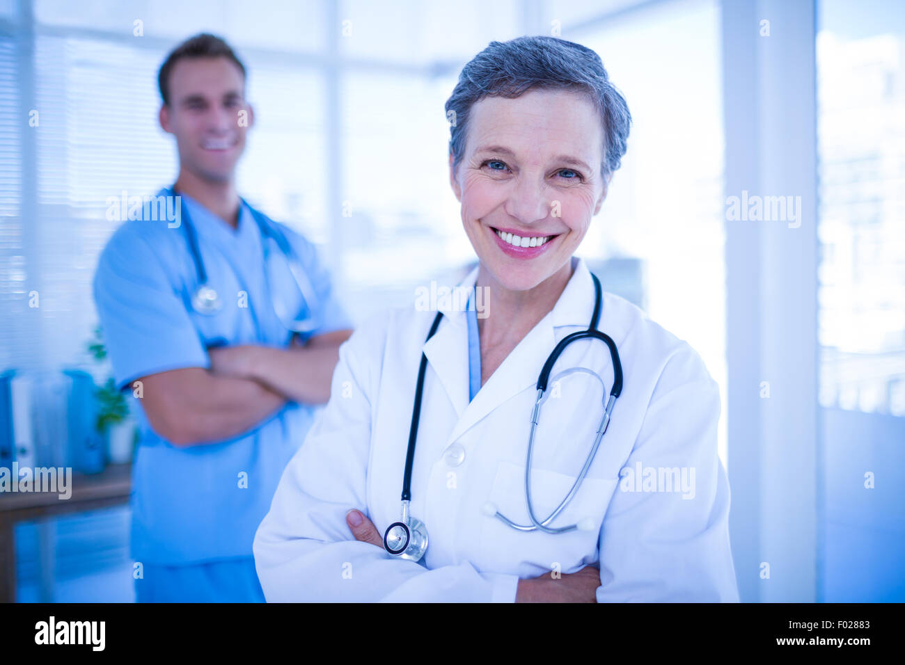 Smiling colleagues doctors looking at the camera Stock Photo - Alamy