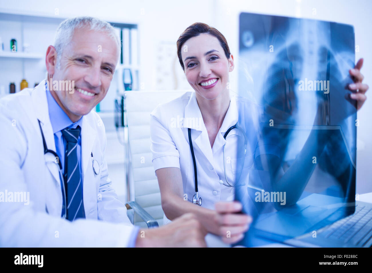Portrait of smiling medical colleagues holding x-ray Stock Photo - Alamy
