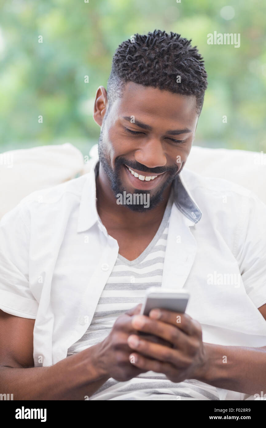Casual man using his smartphone Stock Photo - Alamy