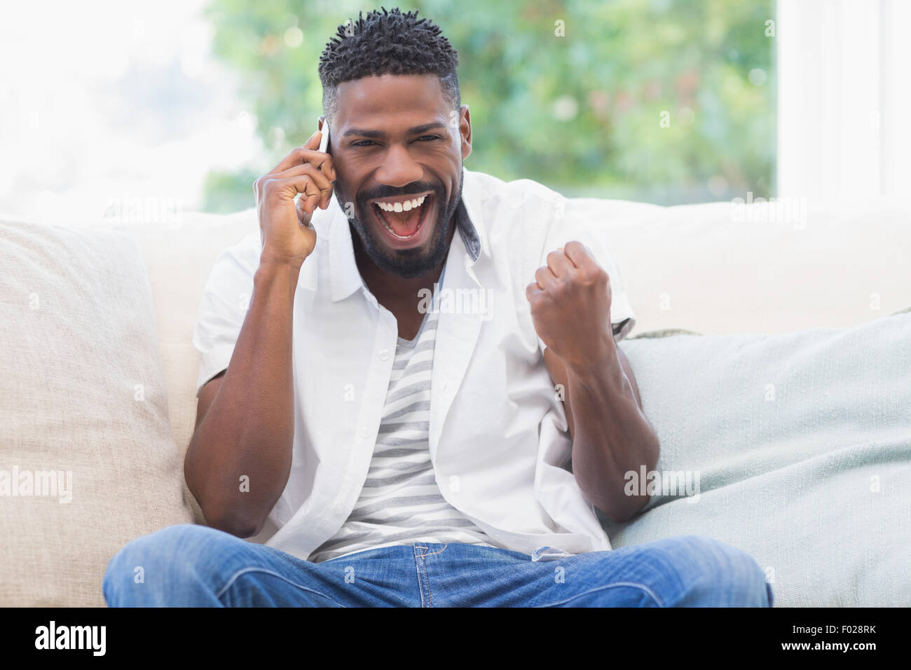 Excited man holding smartphone hi-res stock photography and images - Alamy