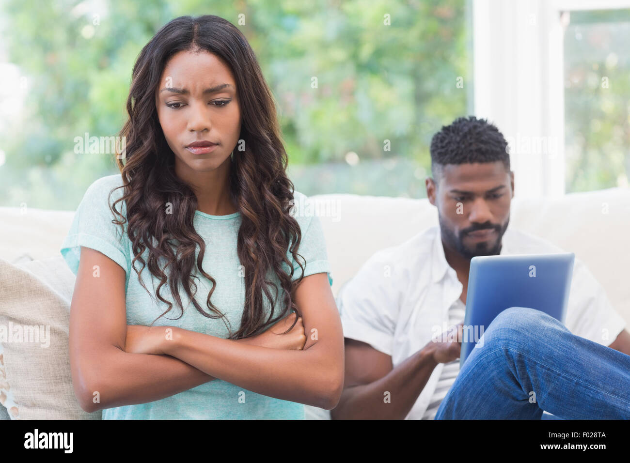 Upset woman being ignored by partner Stock Photo - Alamy