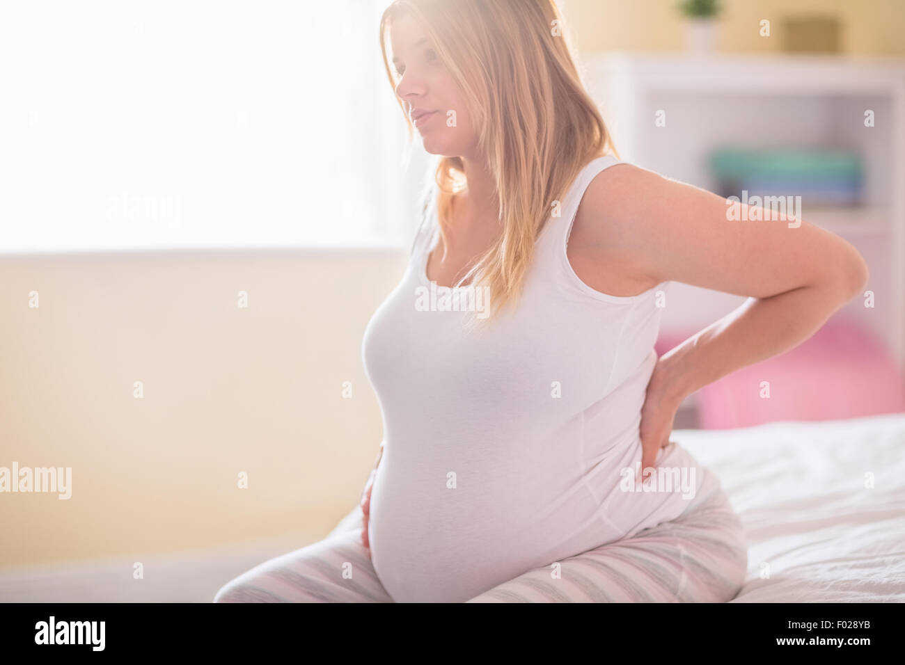 Pregnant woman with back pain Stock Photo - Alamy