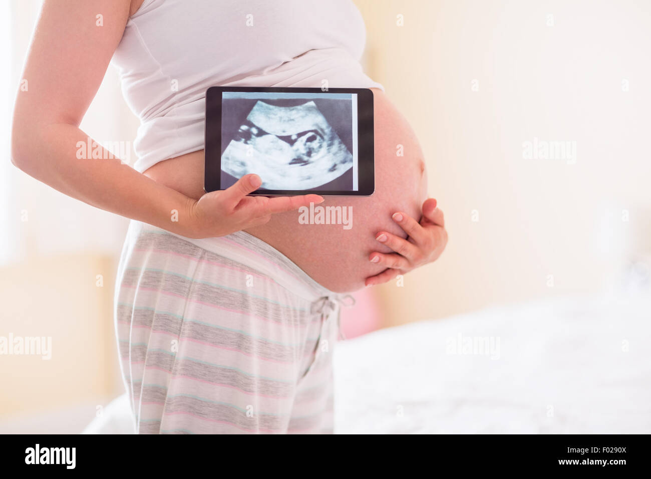 Pregnant woman showing ultrasound scans Stock Photo - Alamy