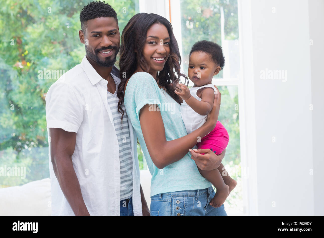 Happy parents with baby girl Stock Photo - Alamy