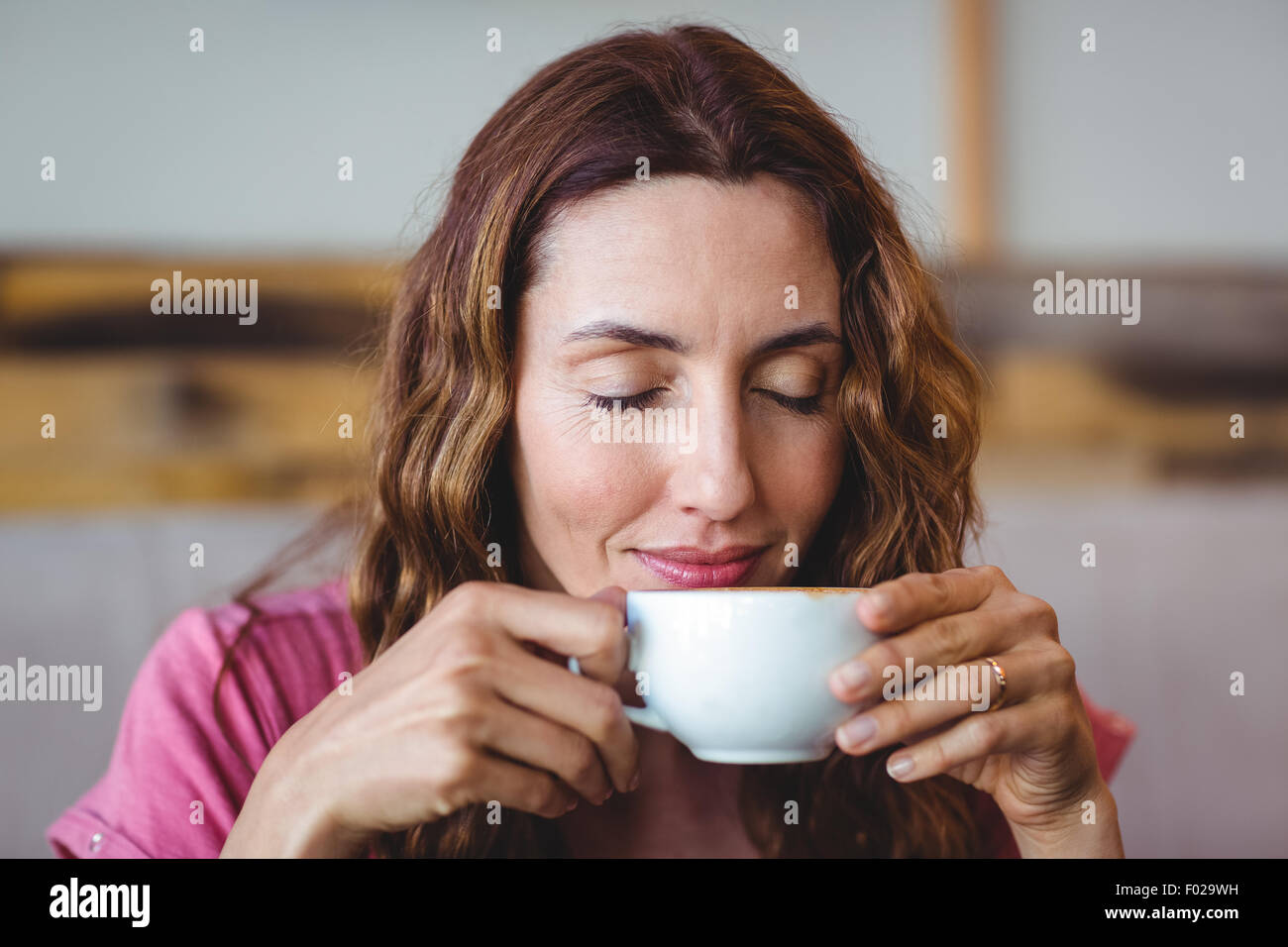 Young woman having a coffee Stock Photo - Alamy