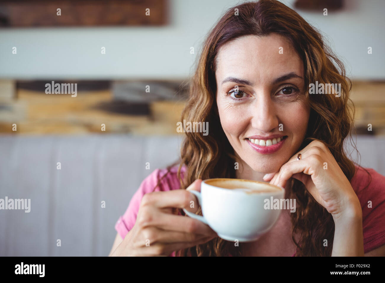 Young woman having a coffee Stock Photo - Alamy
