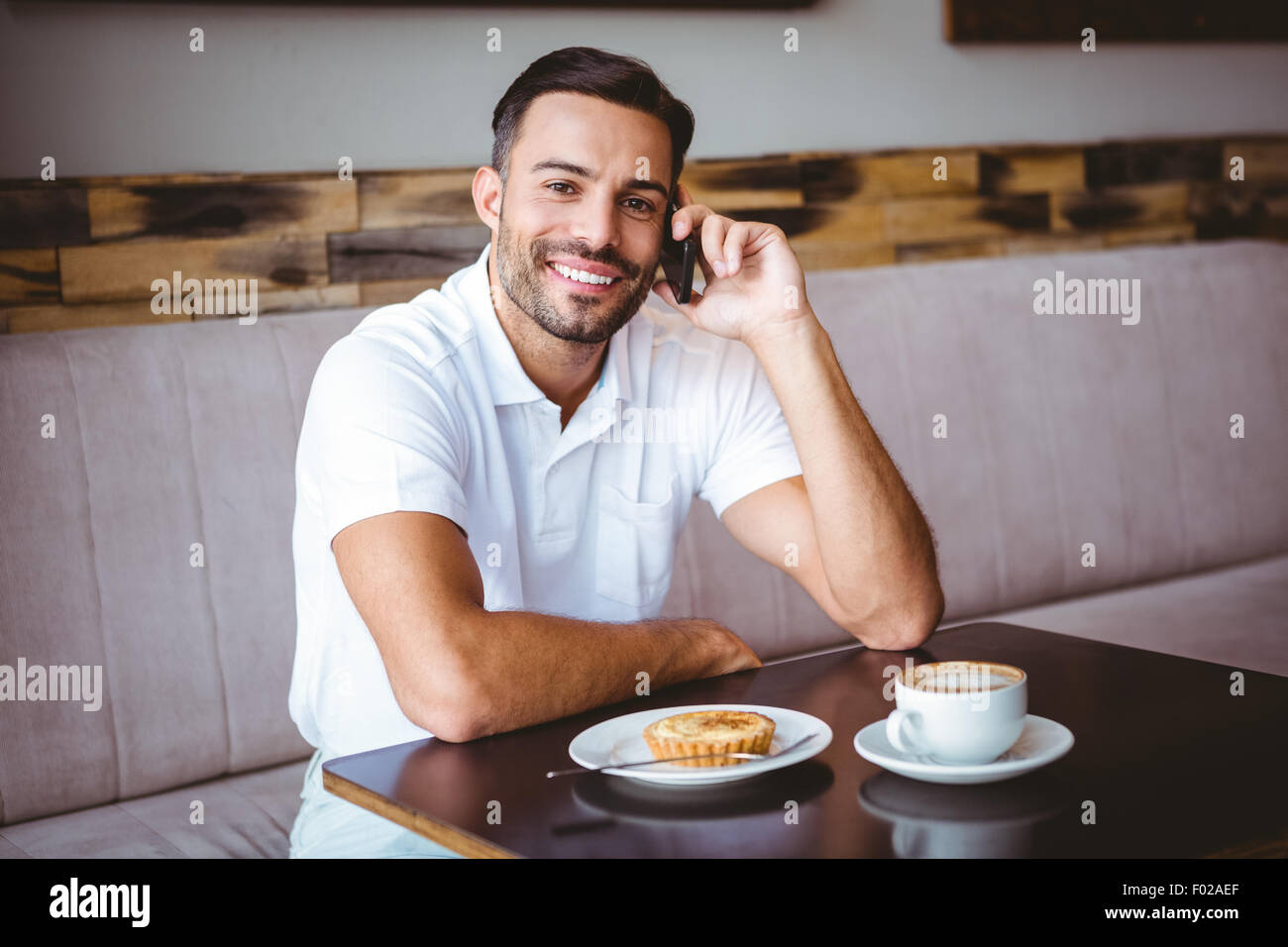 Young man smiling on the phone Stock Photo - Alamy