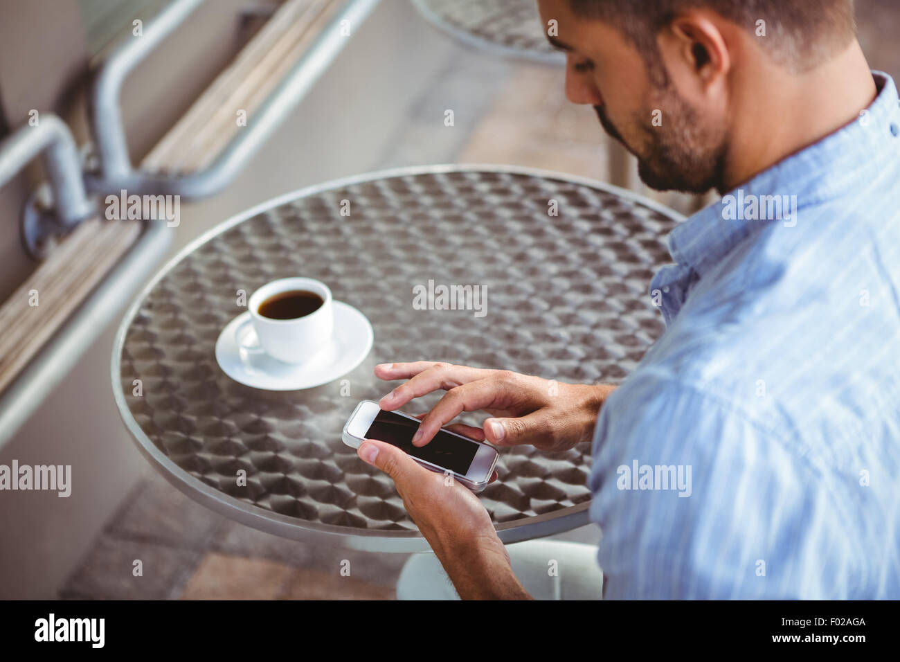 Attentive businessman sending text message Stock Photo - Alamy