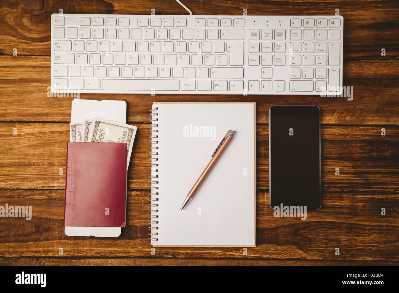 Pen on notepad passport smartphone and keyboard Stock Photo - Alamy