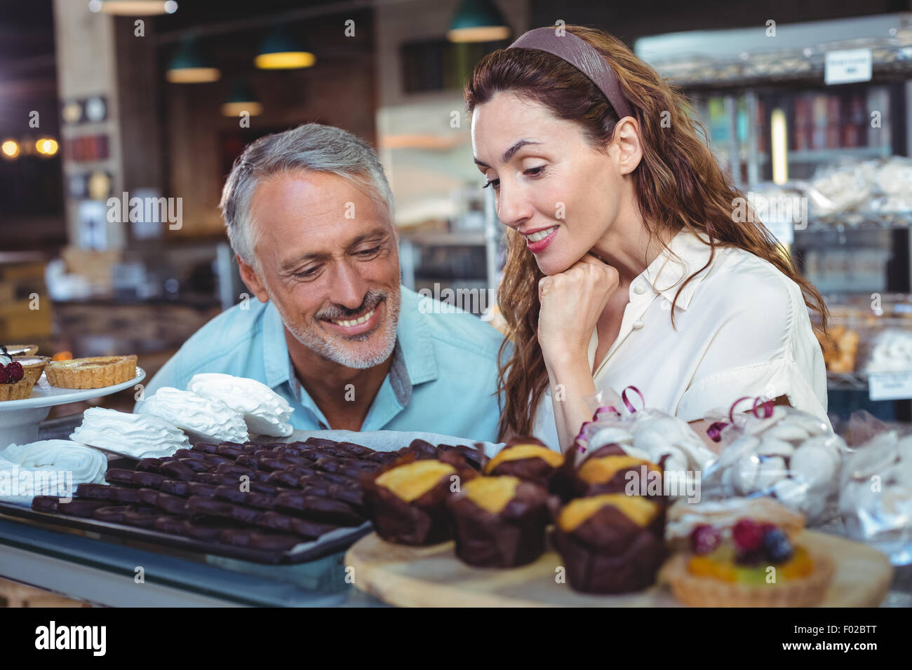 Cute couple looking at cakes Stock Photo - Alamy