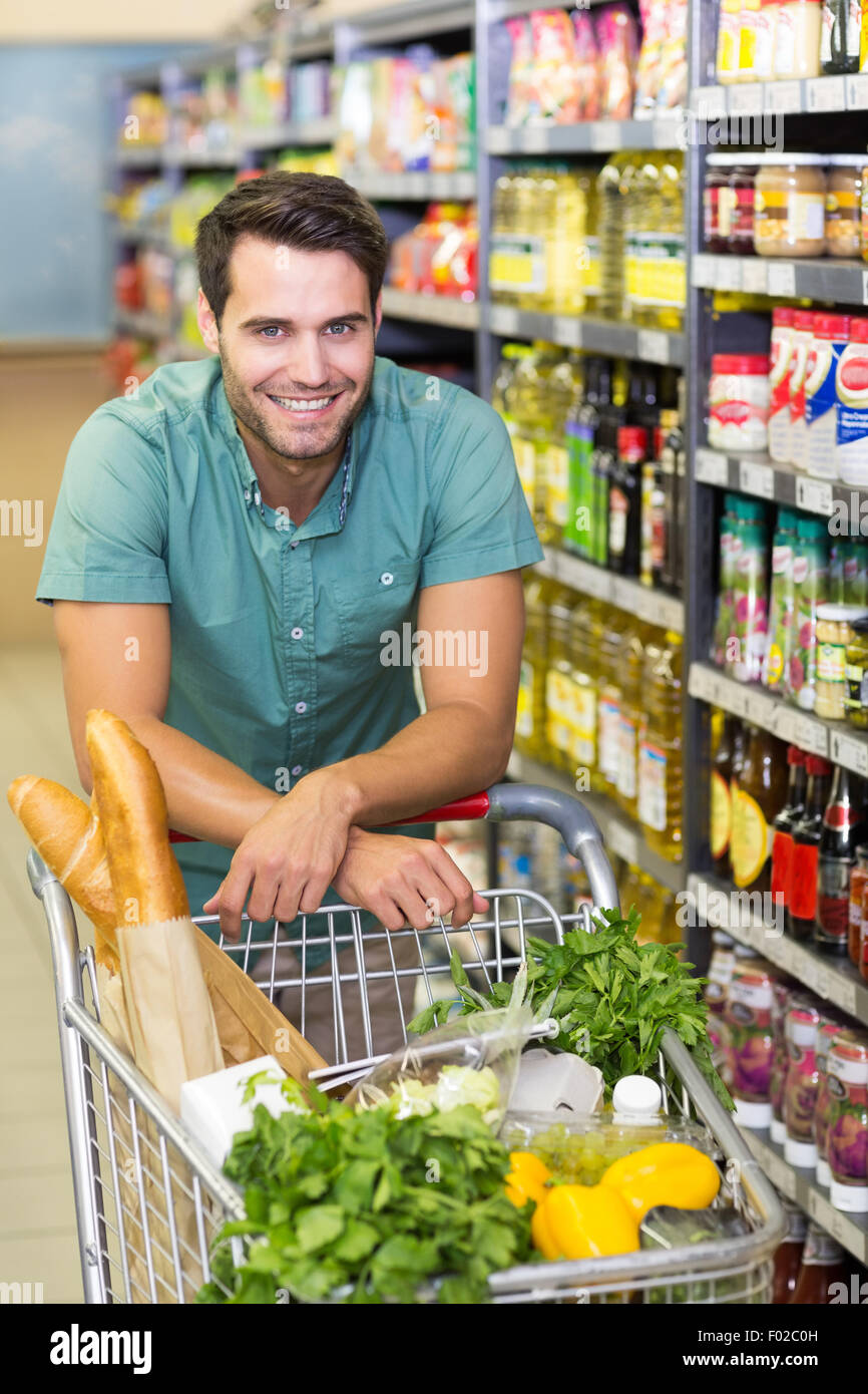 Portrait of smiling man buy product with his trolley Stock Photo - Alamy