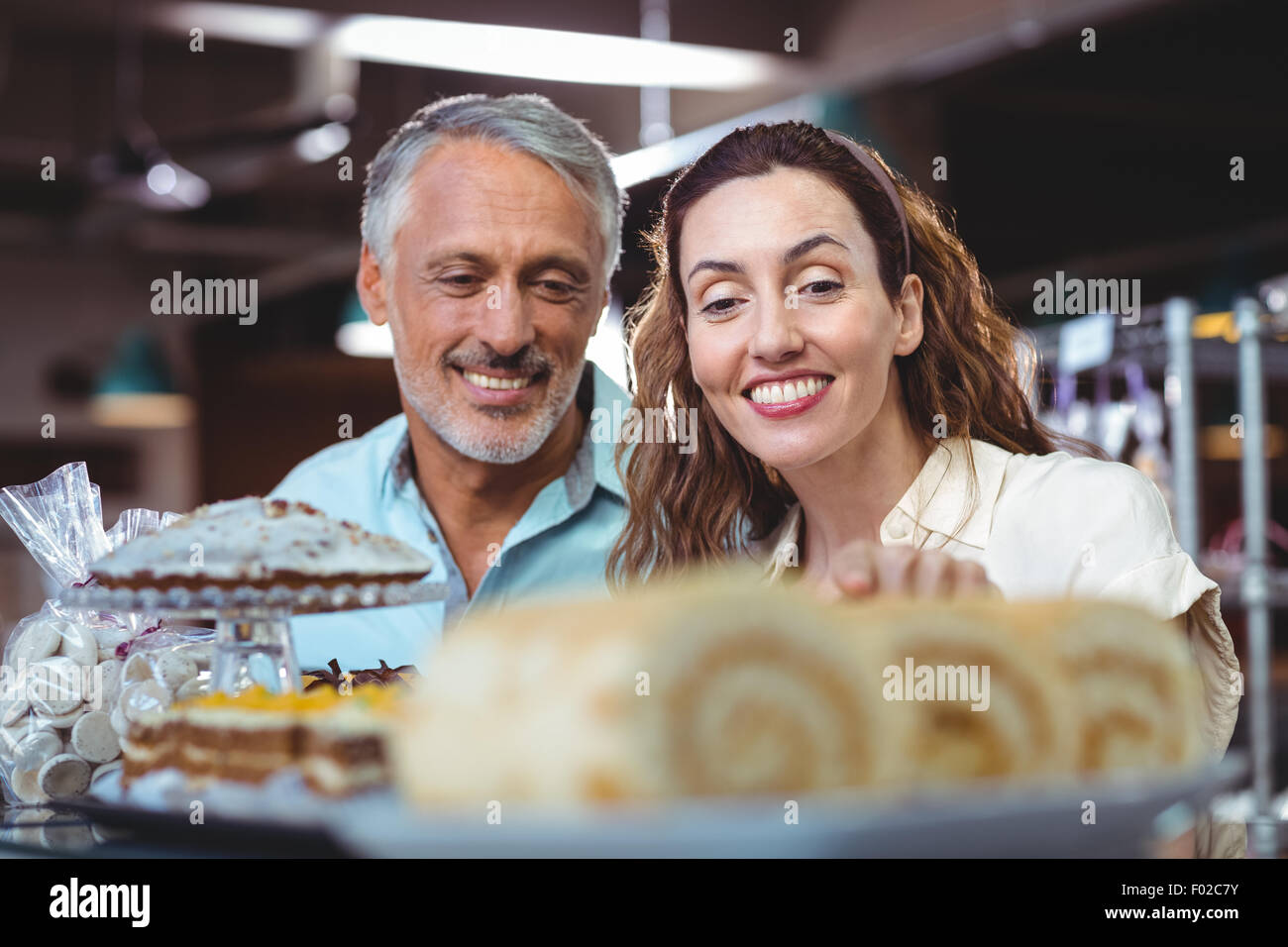Cute couple looking at cakes Stock Photo - Alamy