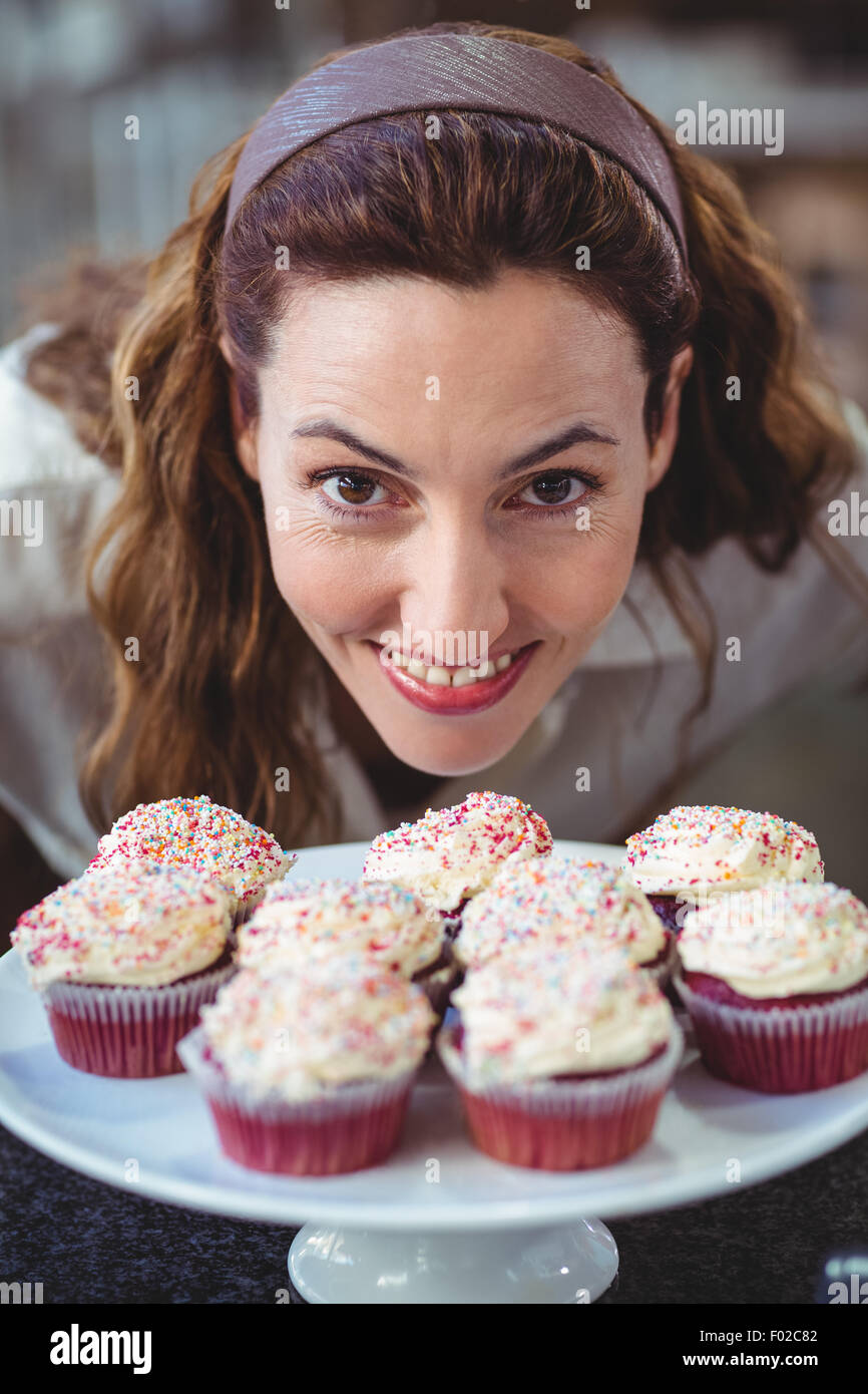 Pretty brunette looking at cakes Stock Photo - Alamy