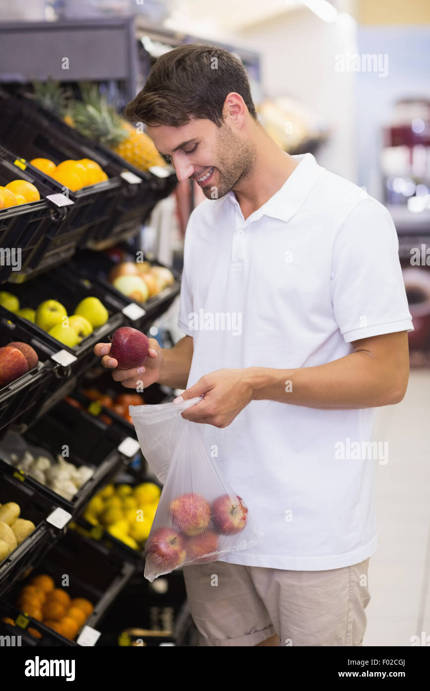 Smiling handsome buying a fruits Stock Photo - Alamy