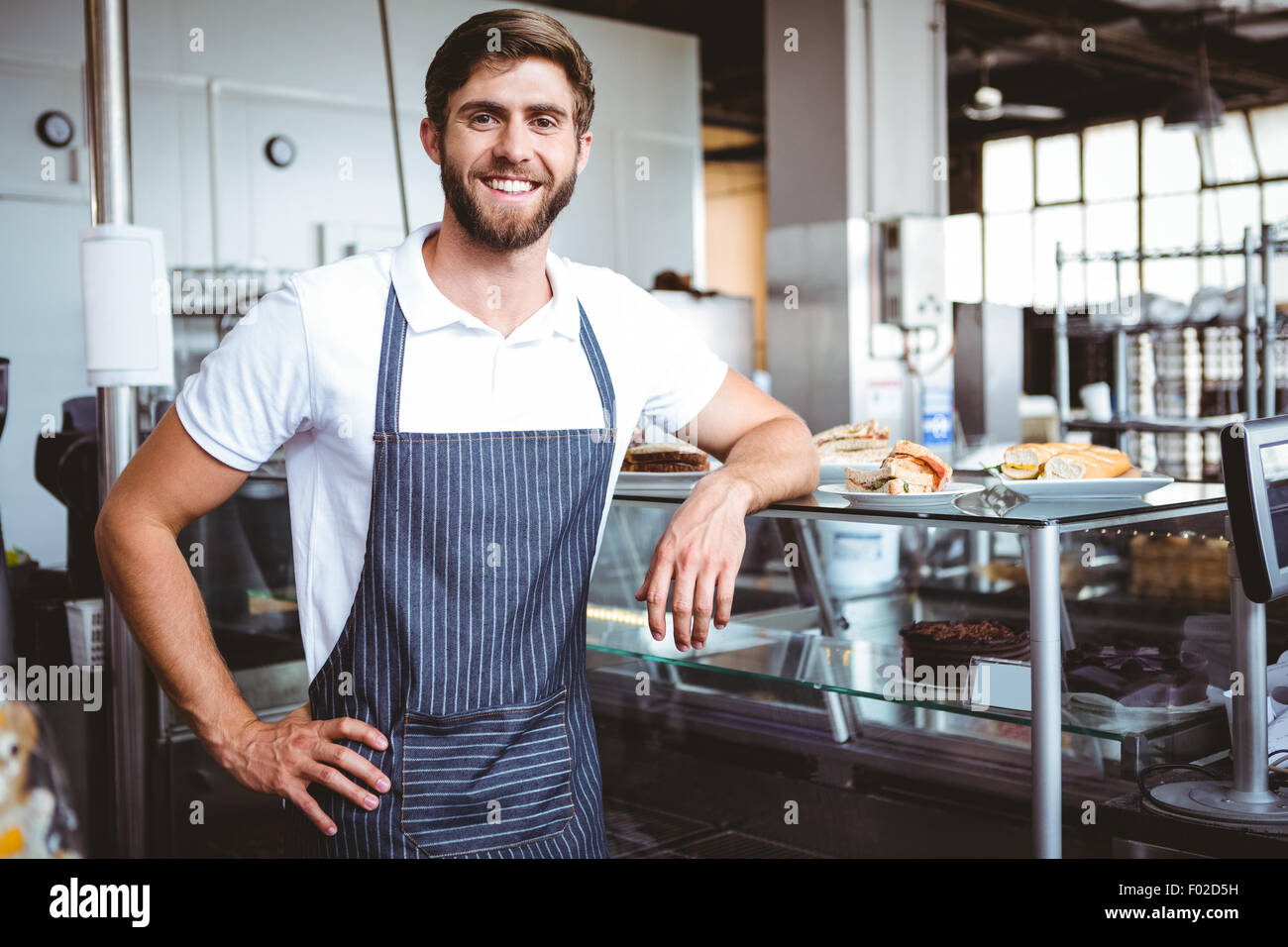 Handsome worker posing on the counter Stock Photo - Alamy