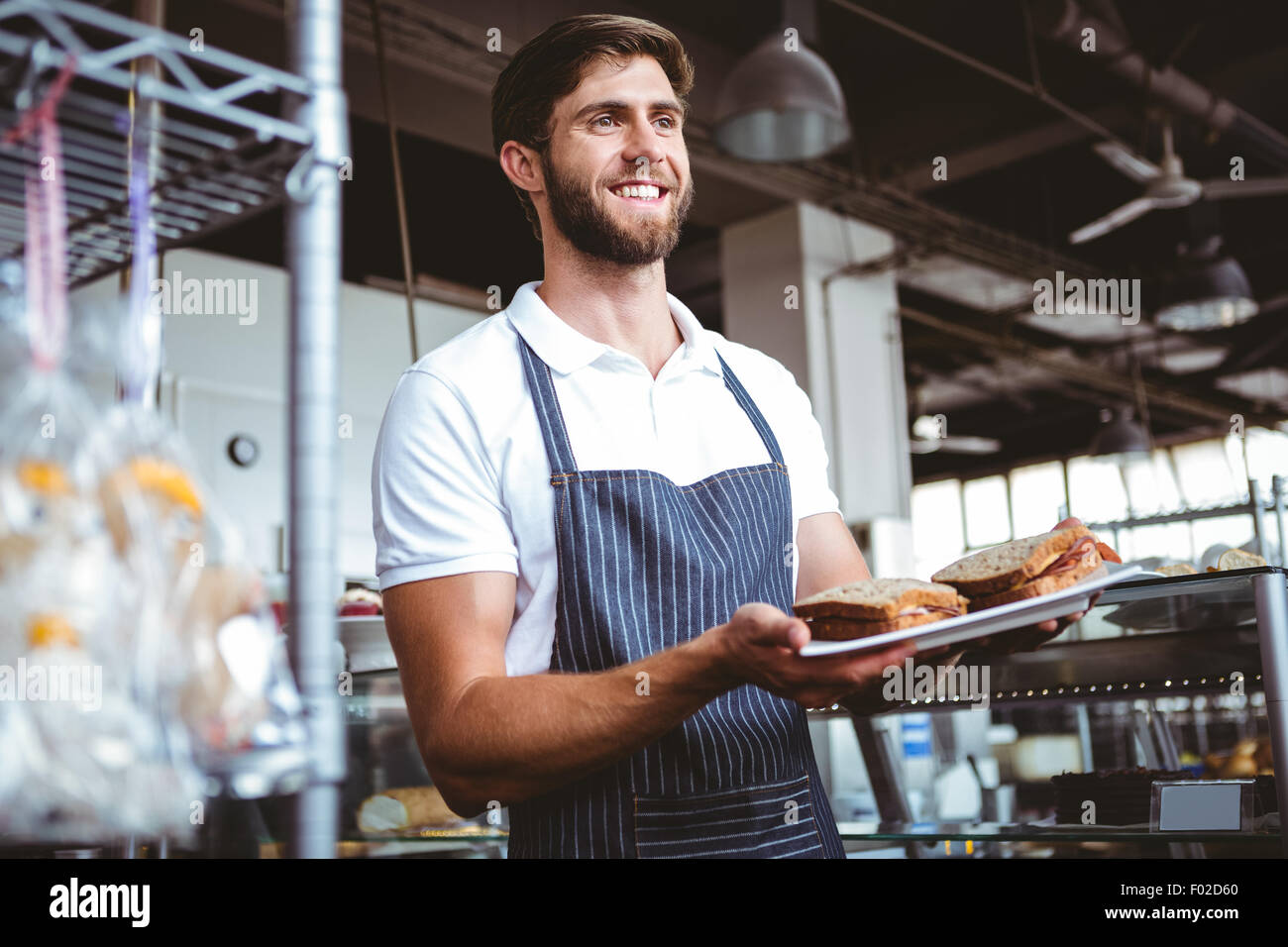 happy worker holding sandwiches Stock Photo - Alamy