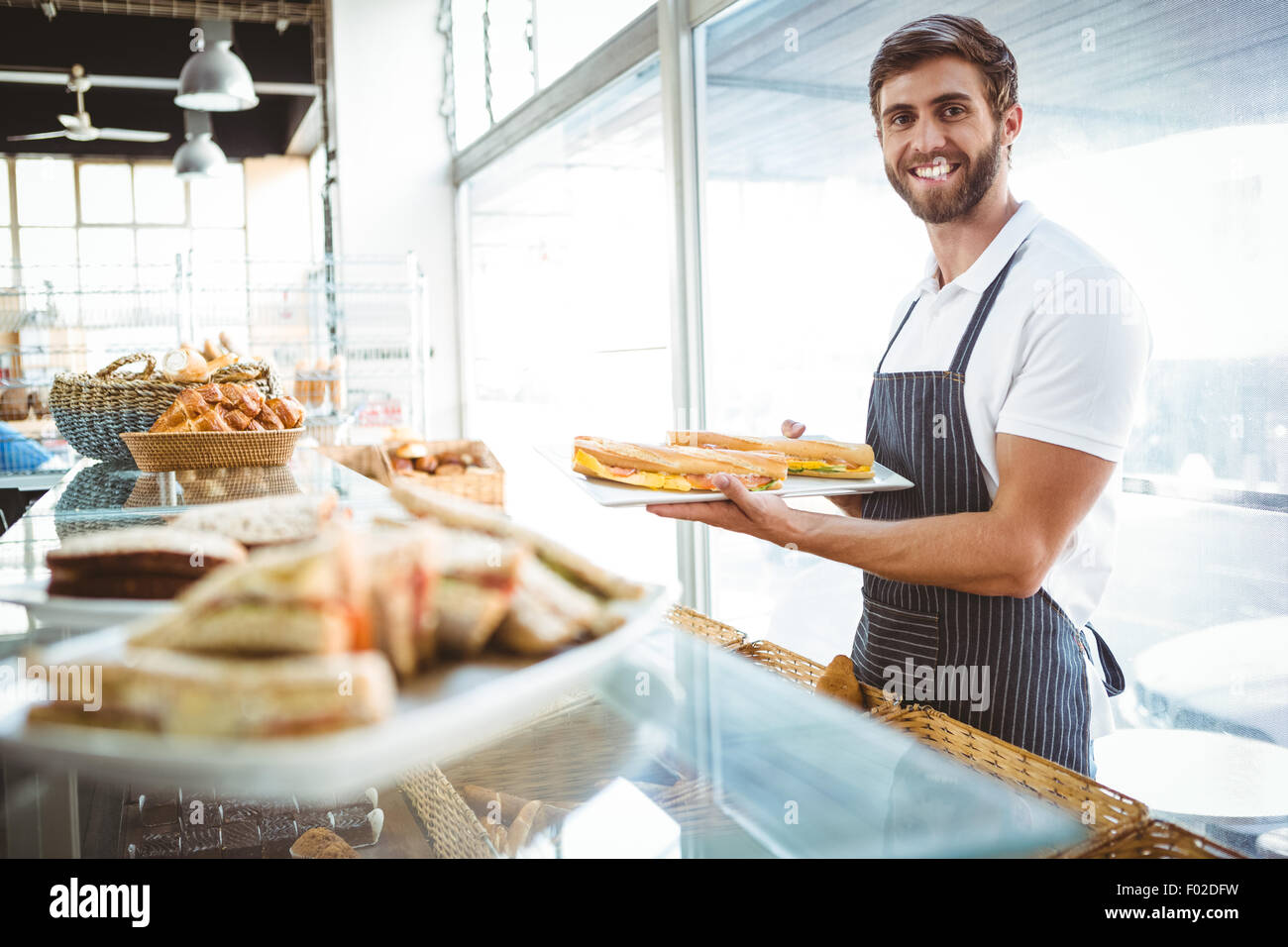 happy worker holding sandwiches Stock Photo - Alamy