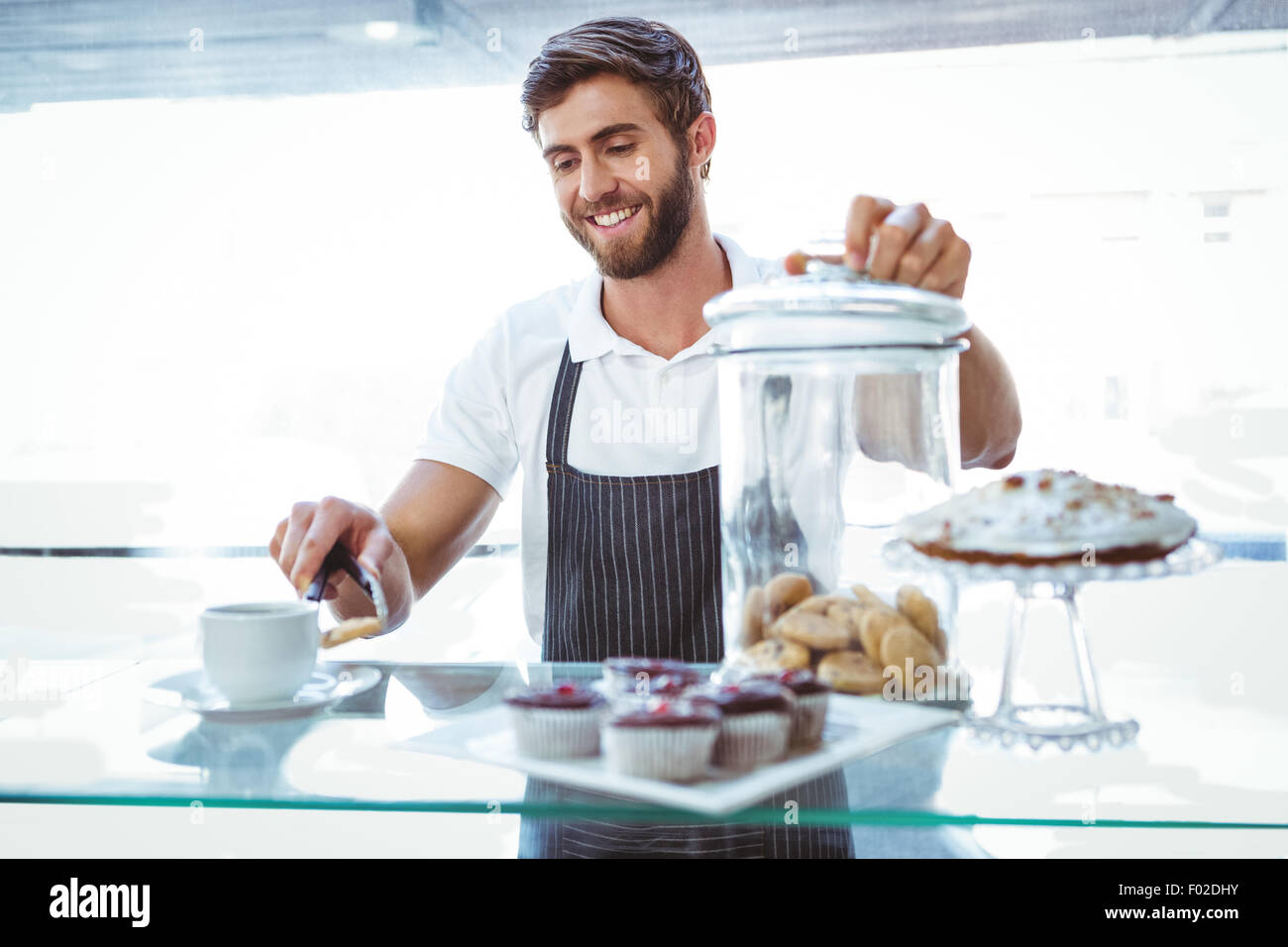 Smiling worker prepares breakfast Stock Photo - Alamy