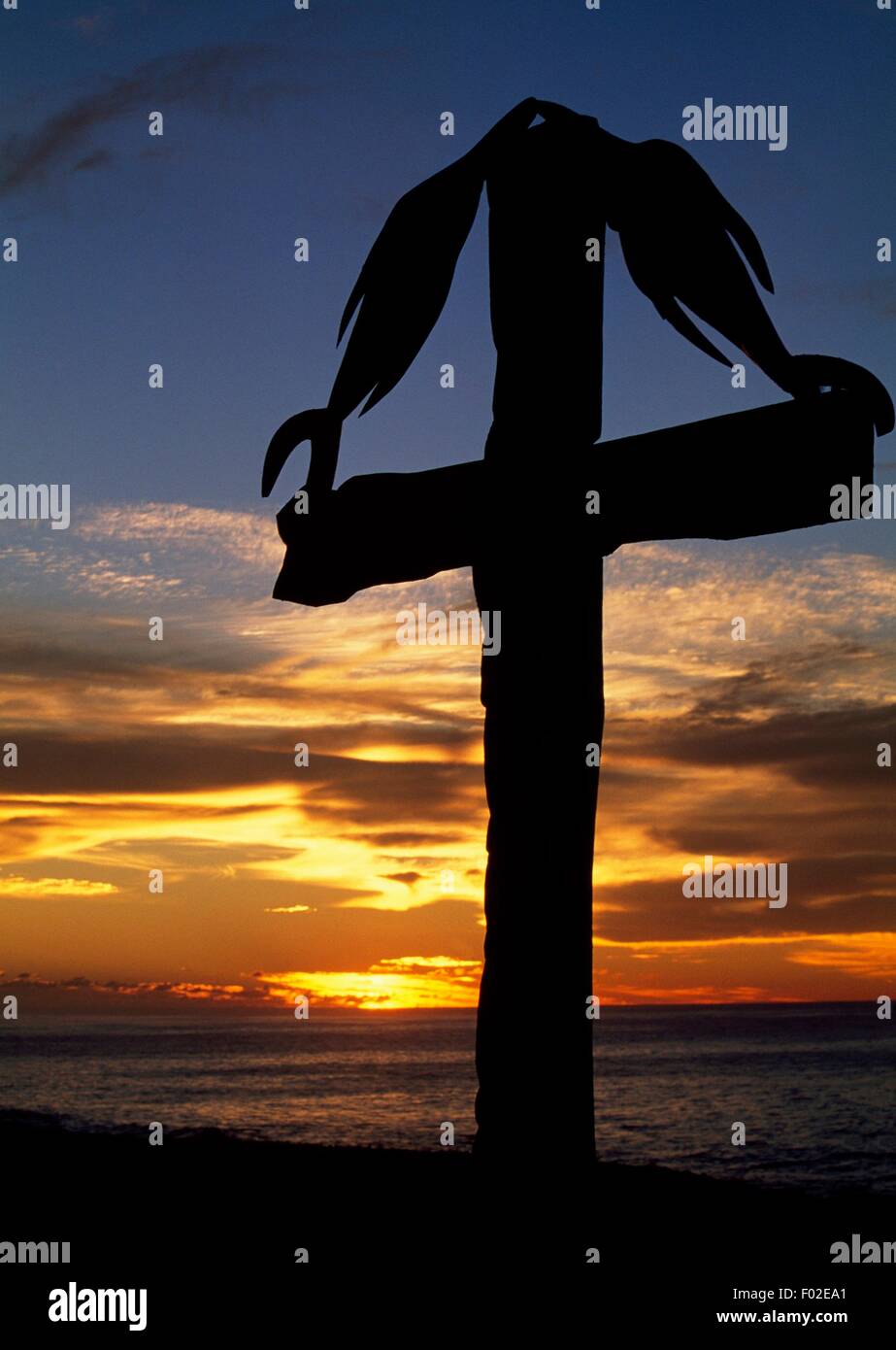 Cross at sunset on the south coast of Easter Island, Rapa Nui National ...