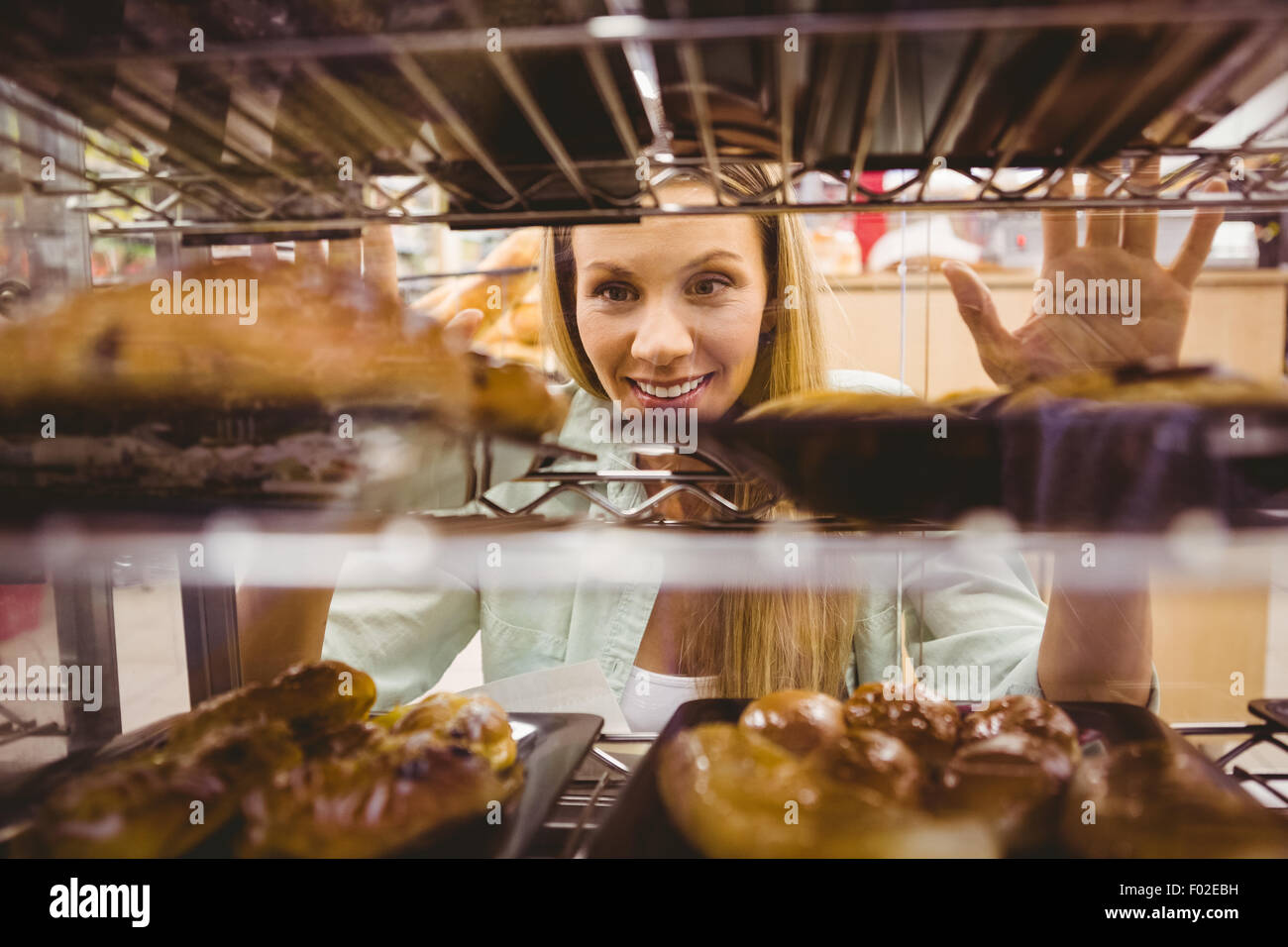 Portrait of a woman looking at new plates with pastries Stock Photo - Alamy