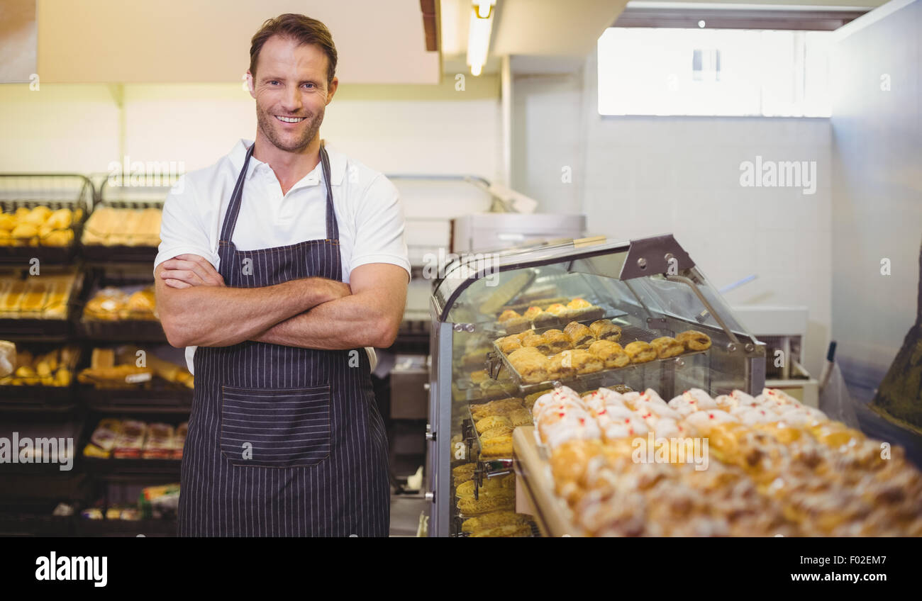 Portrait of a smiling baker with arm crossed Stock Photo - Alamy