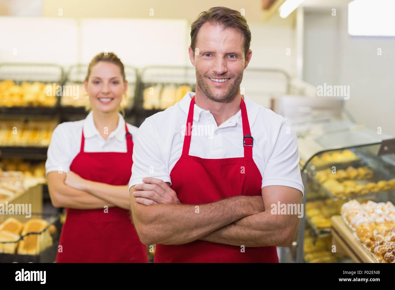 Portrait of smiling two bakers with arms crossed Stock Photo - Alamy