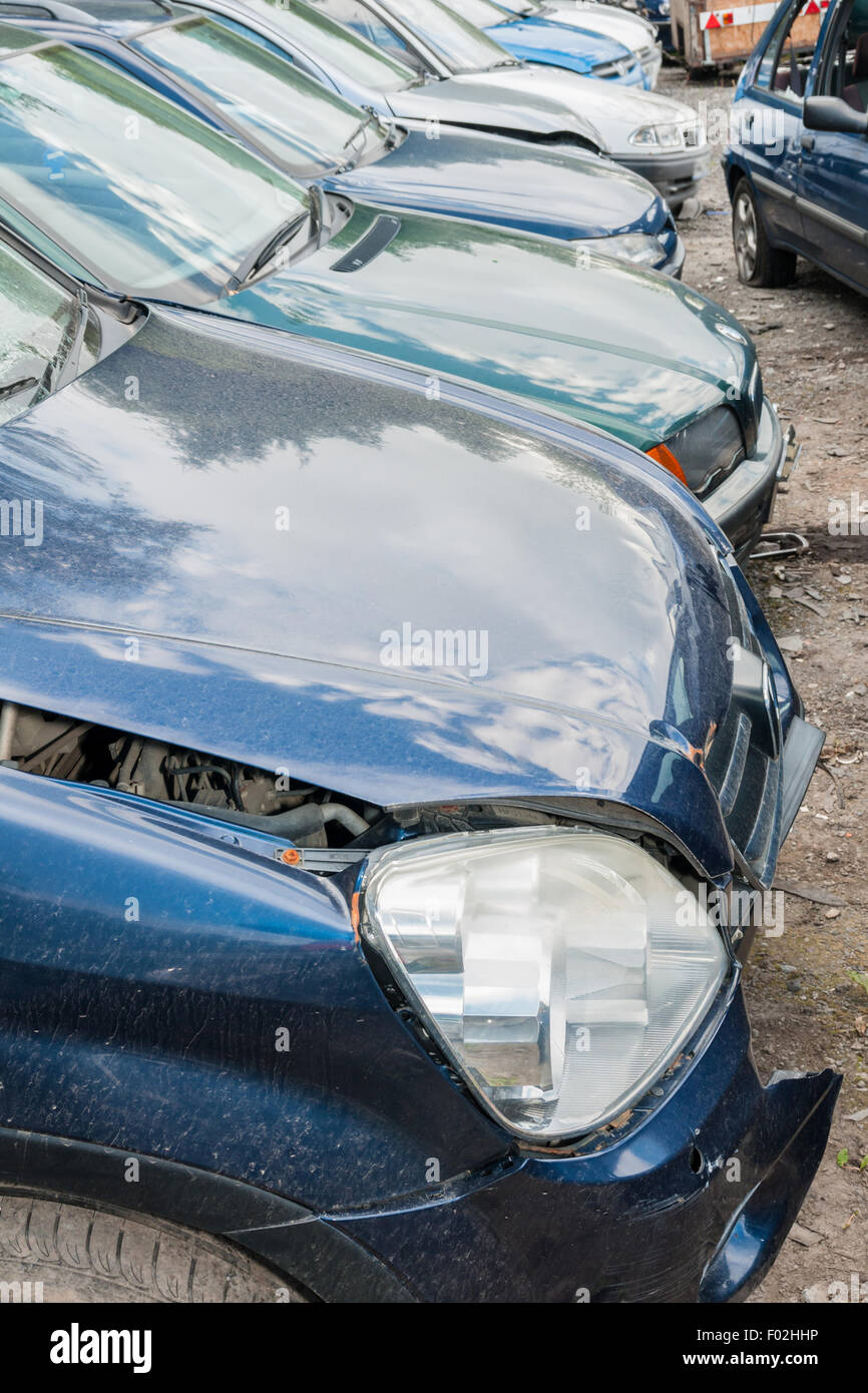 Scrap accident damaged cars or automobiles in a junk yard waiting for ...