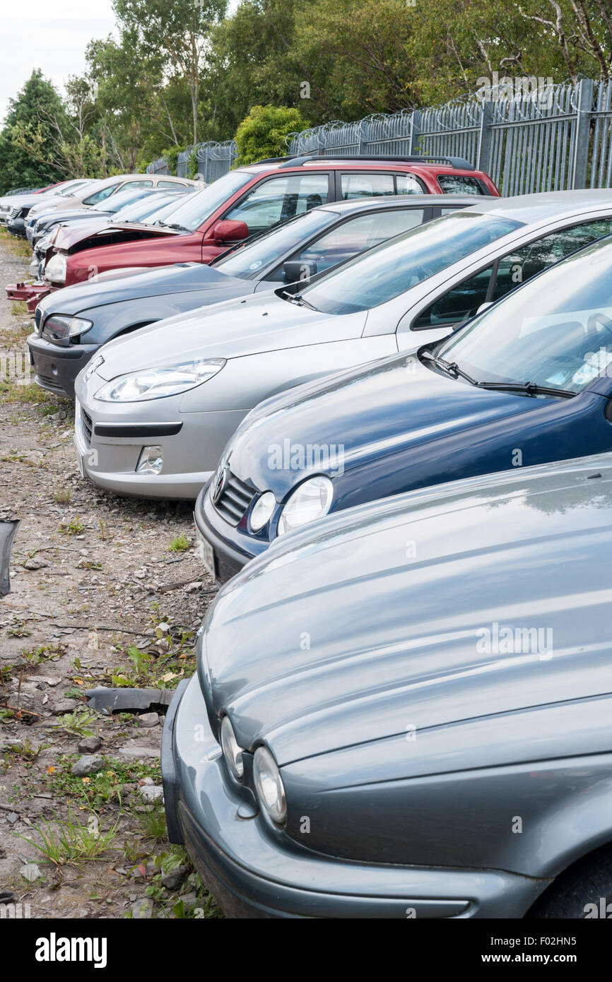 Scrap accident damaged cars or automobiles in a junk yard waiting for ...