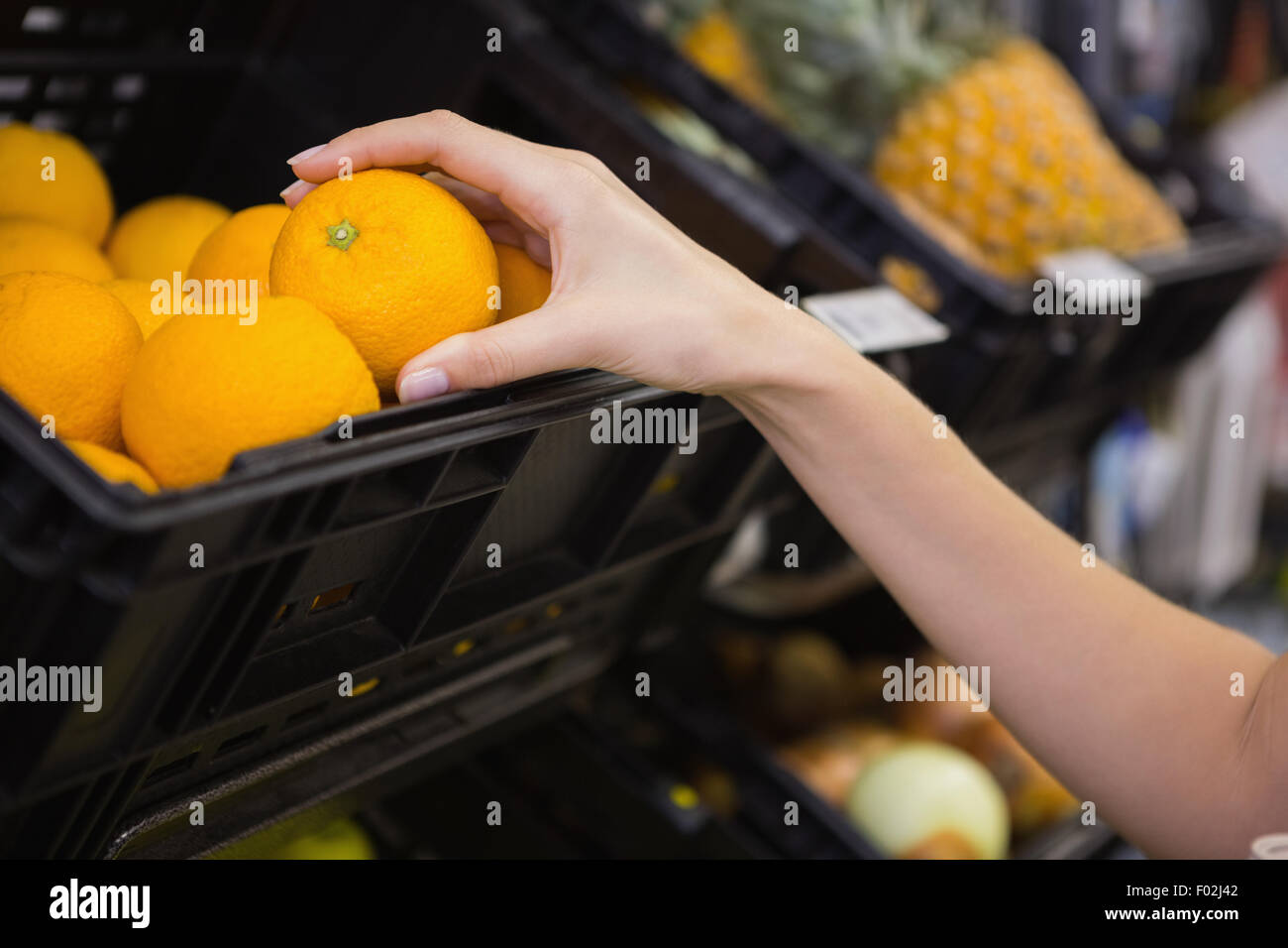 Smiling pretty blonde woman buying oranges Stock Photo - Alamy