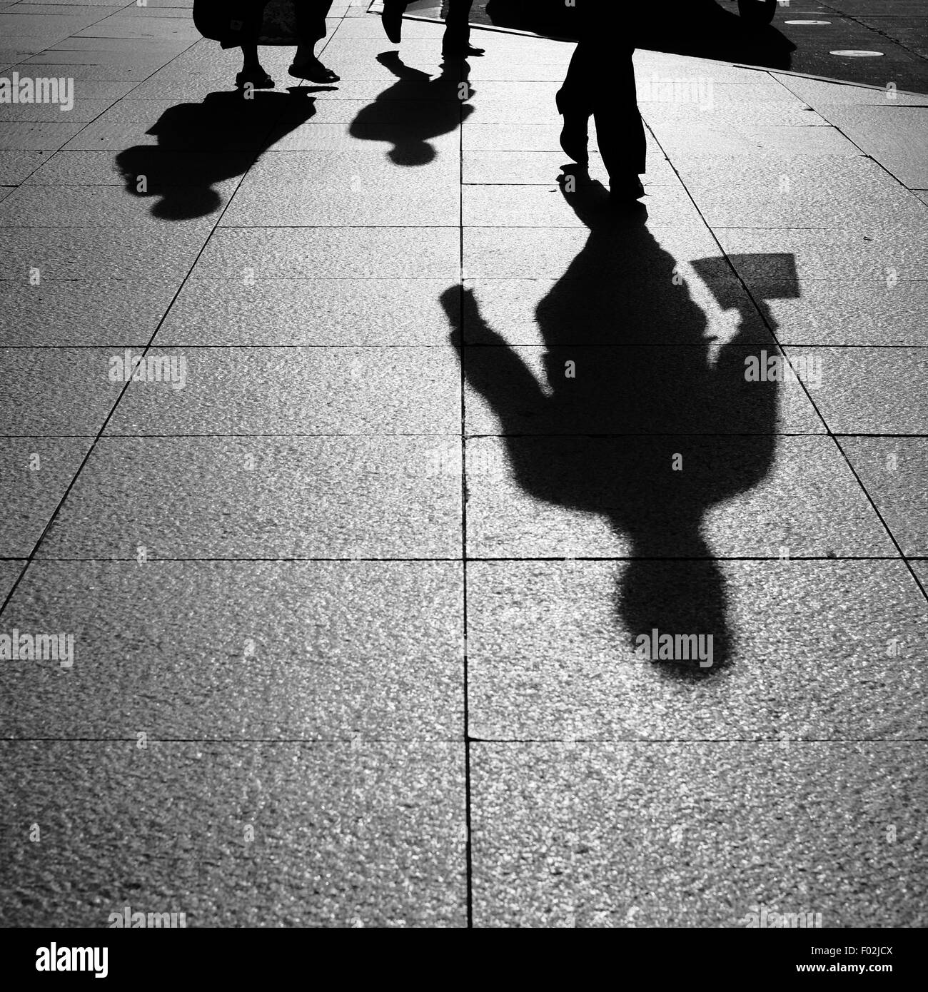 Shadows and Silhouettes of people walking on street in city Stock Photo ...