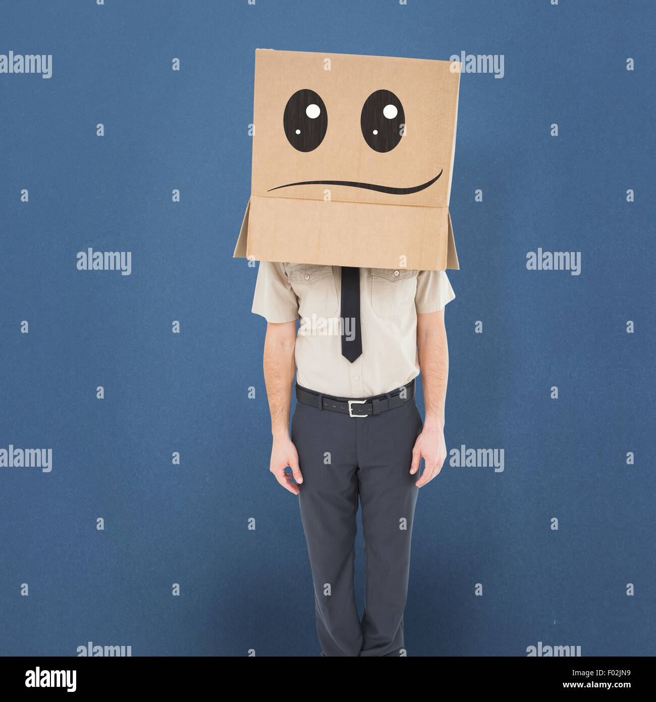 Composite image of businessman standing with box on head Stock Photo ...