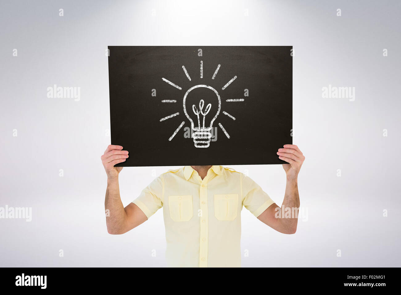 Composite image of casual man showing board Stock Photo - Alamy