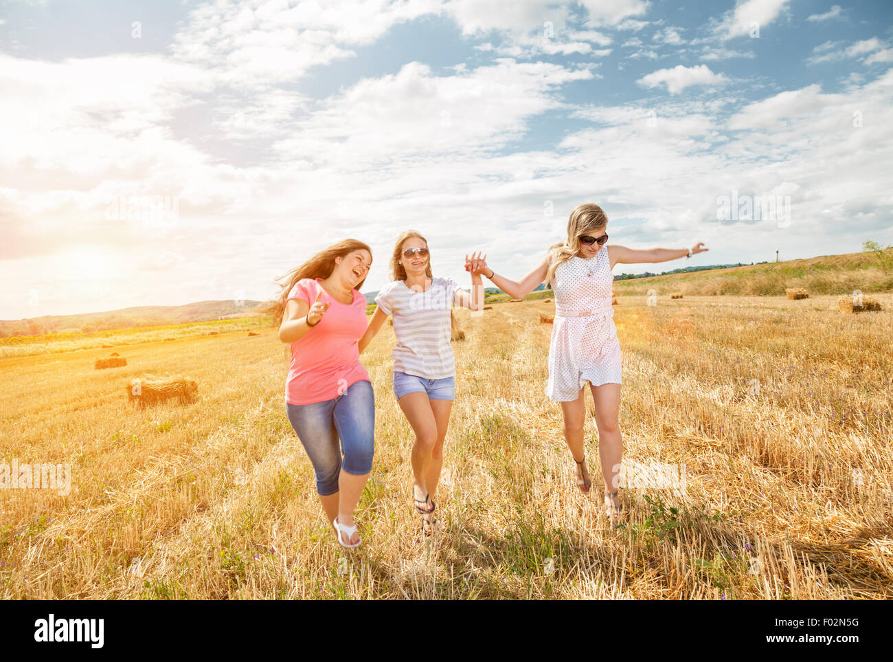 Three best friends having fun outdoors on a sunny day Stock Photo - Alamy