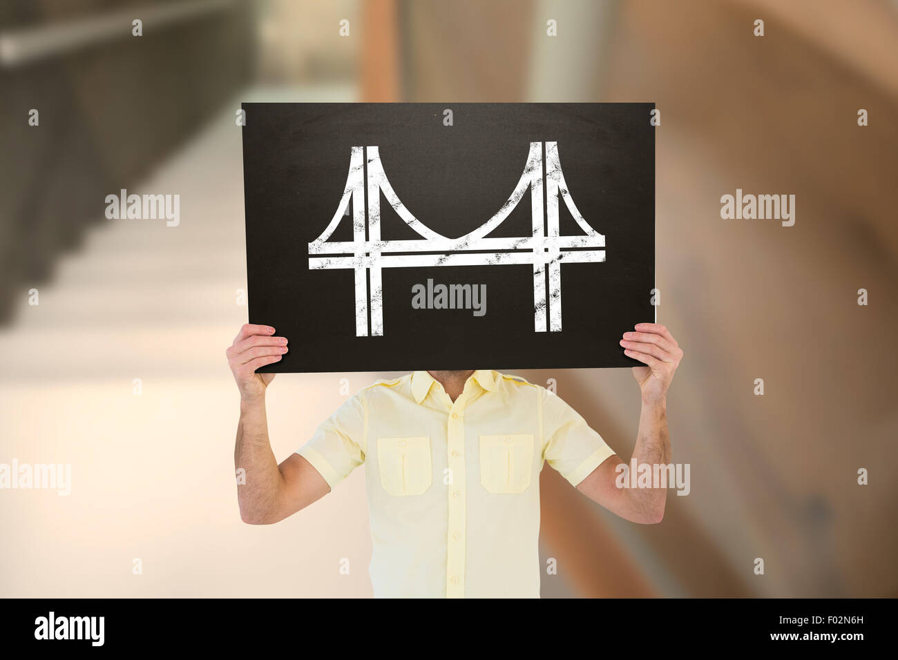 Composite image of casual man showing board Stock Photo - Alamy