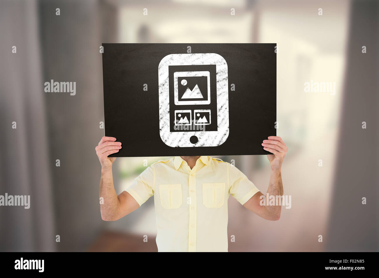 Composite image of casual man showing board Stock Photo - Alamy