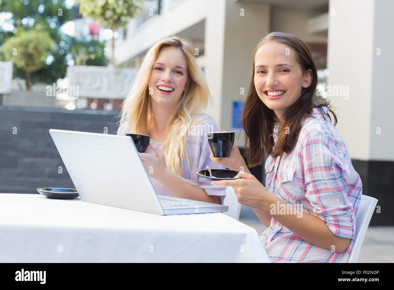 Happy women friends smiling at camera with cups of coffee Stock Photo ...
