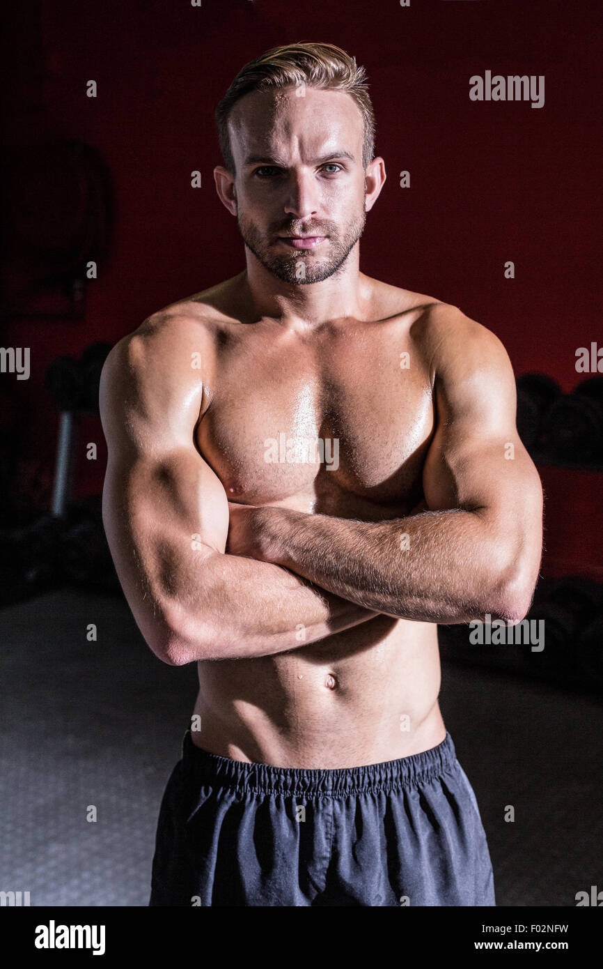 Muscular man with arms crossed Stock Photo - Alamy