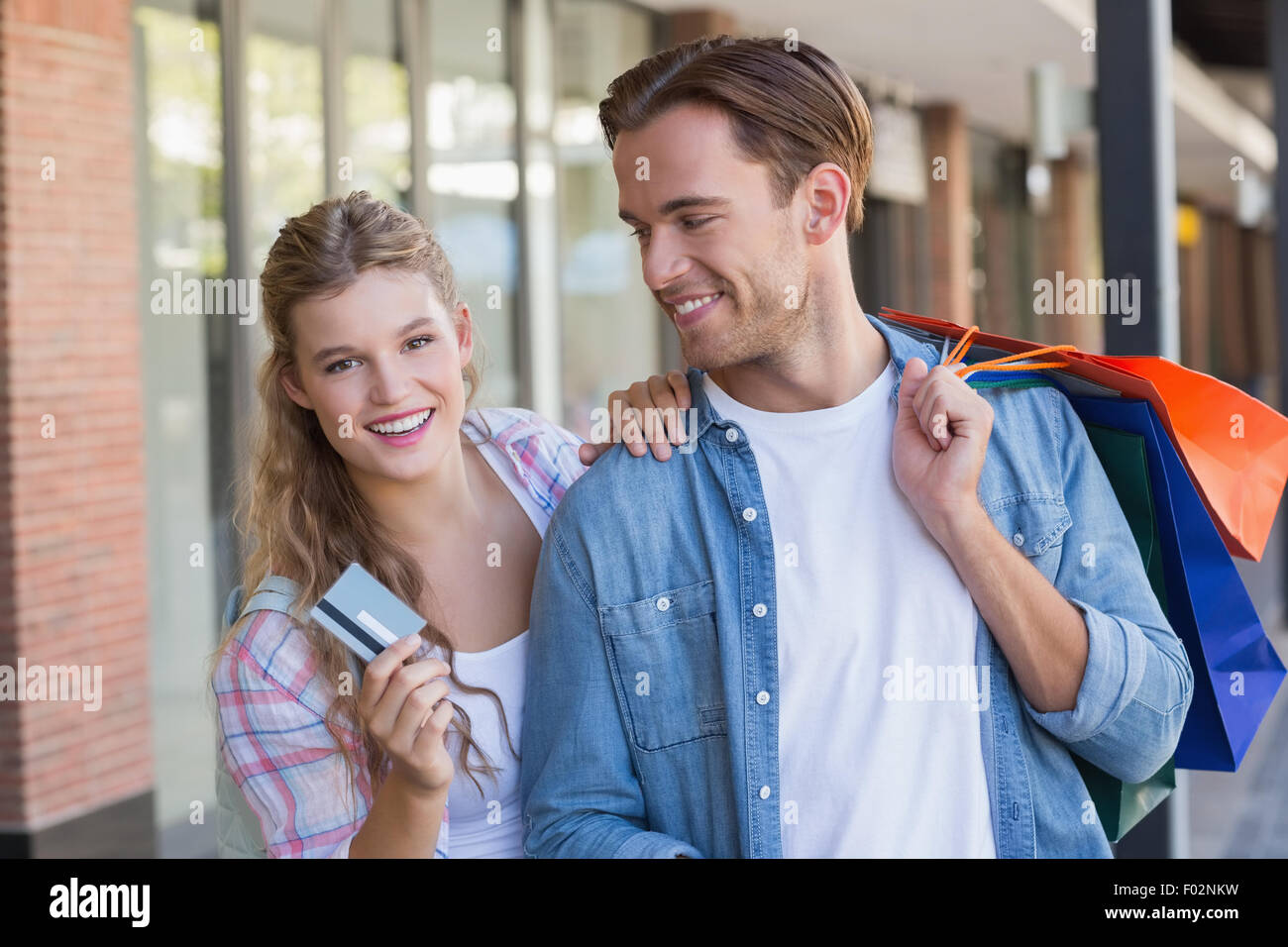 A happy couple showing their new credit card Stock Photo - Alamy
