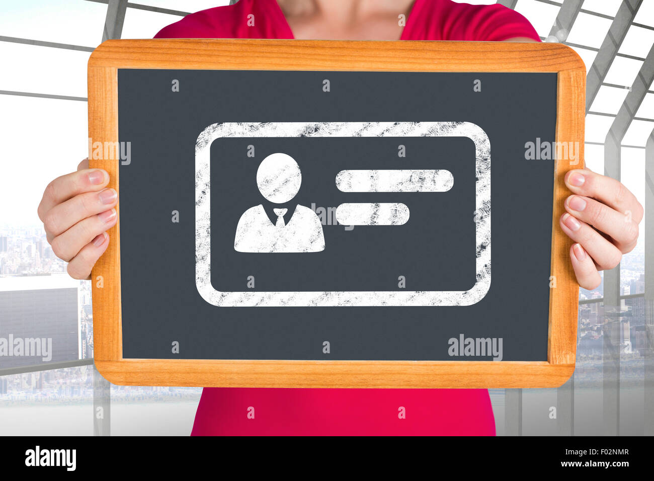 Composite image of woman showing chalkboard to camera Stock Photo - Alamy