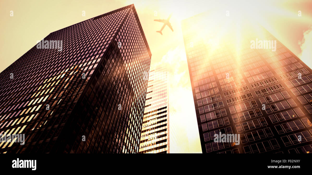 An airplane flying over buildings Stock Photo - Alamy